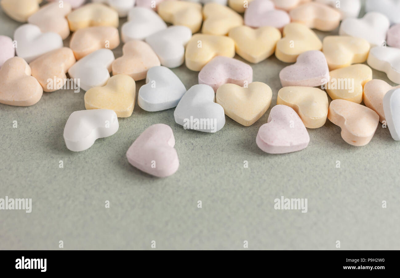 colorful candy hearts on craft background Stock Photo - Alamy