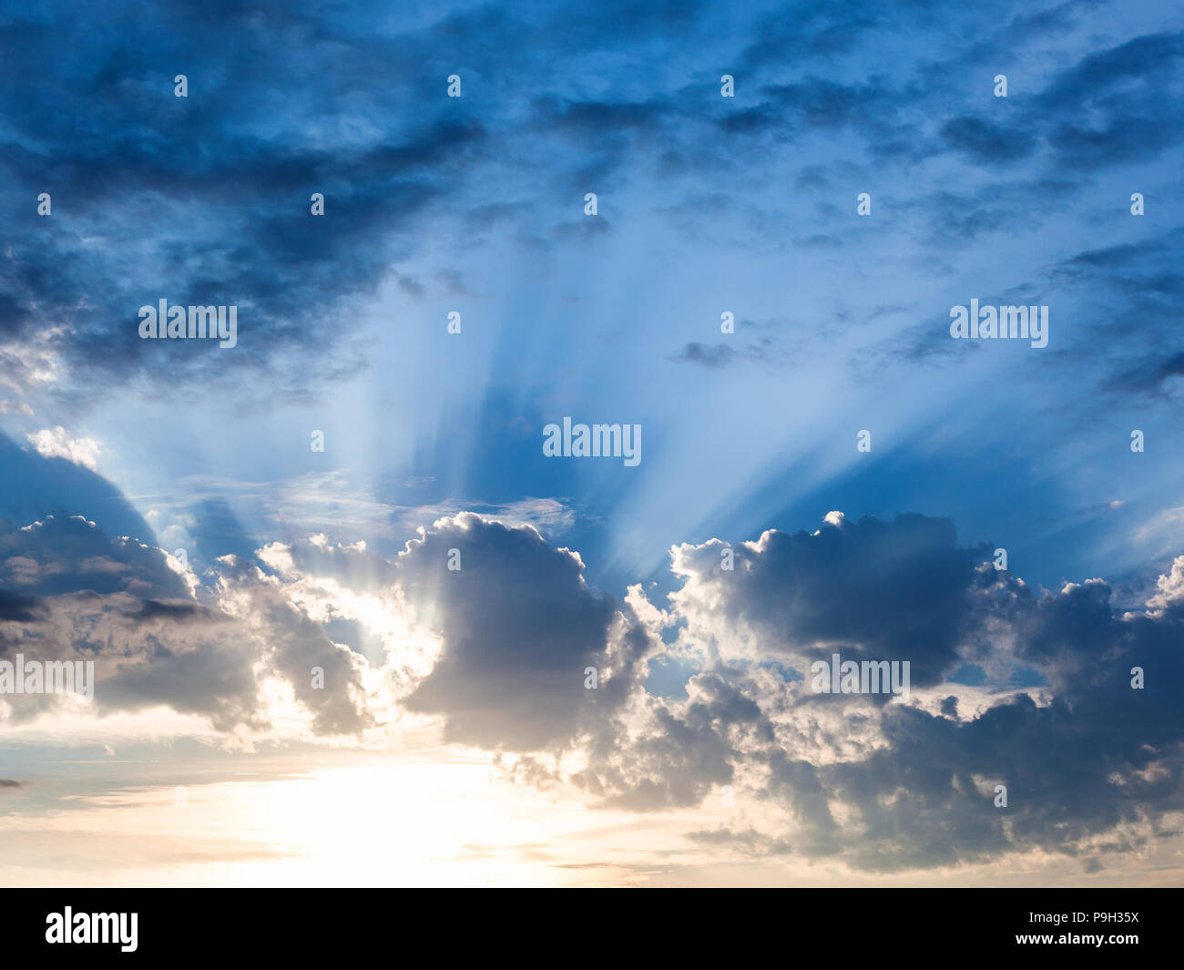 dark blue rainy clouds over sunset sun in summer in Kuban region of ...