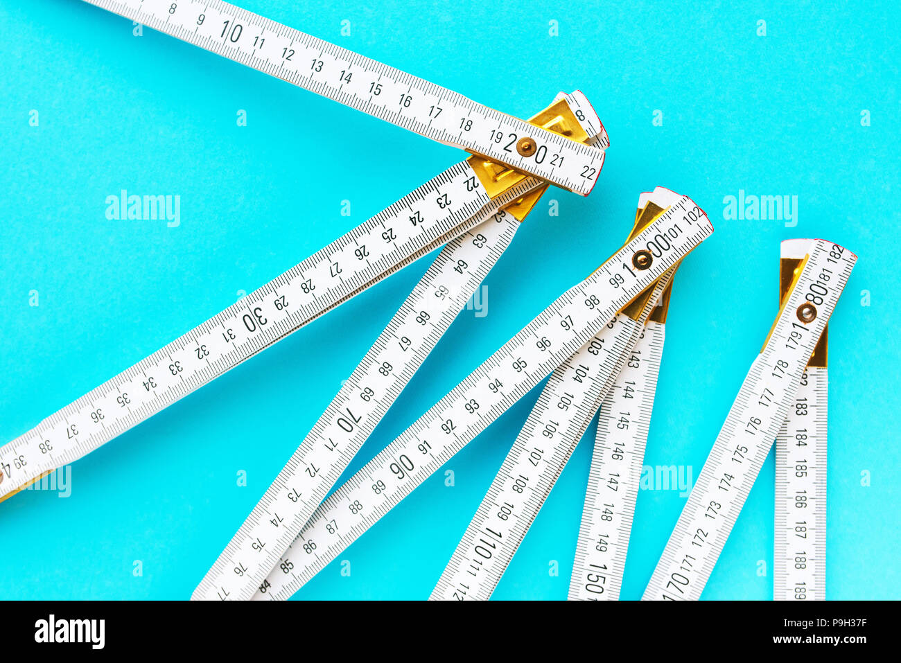 Wood carpenter folding ruler on blue background Stock Photo - Alamy