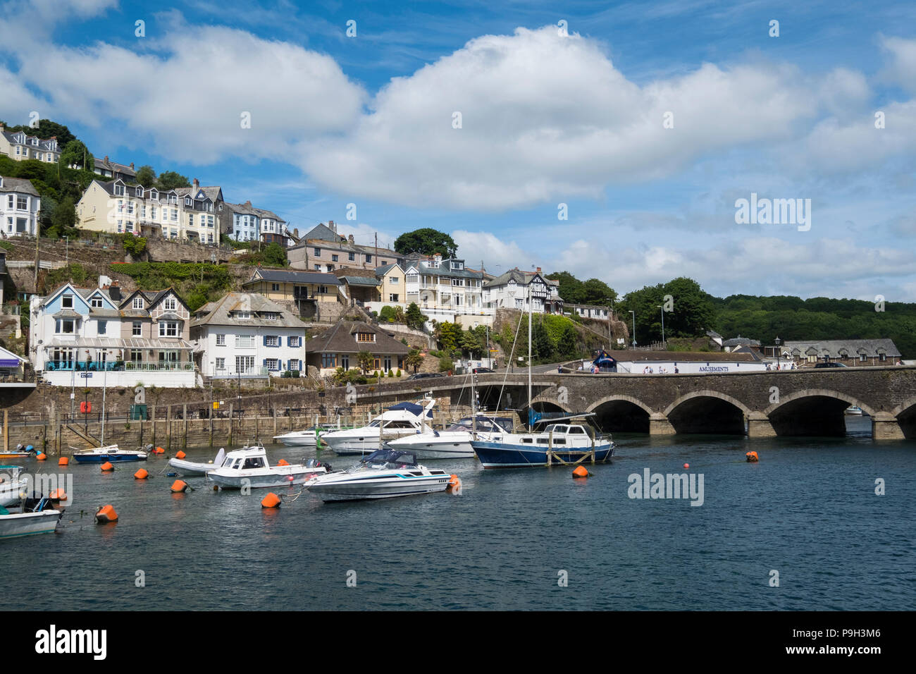 Boats moored on the River Looe beside the bridge at the fishing port of ...