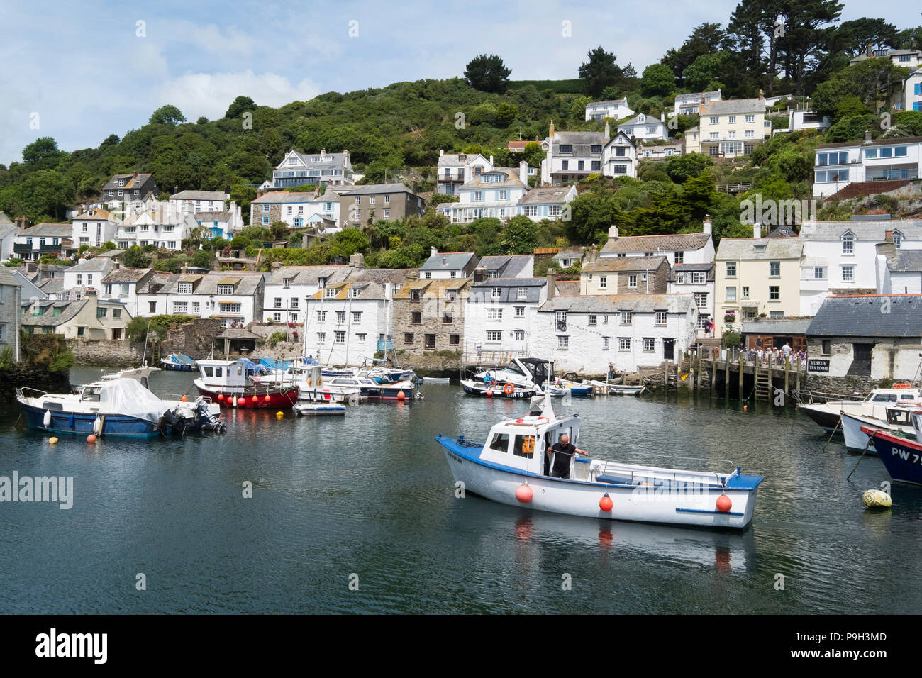 Boats in the harbour at the fishing port of Polperro, Cornwall, England ...