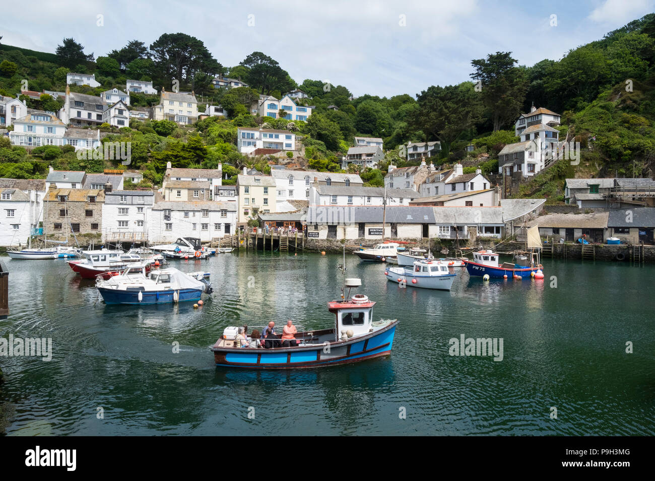 Boats in the harbour at the fishing port of Polperro, Cornwall, England ...