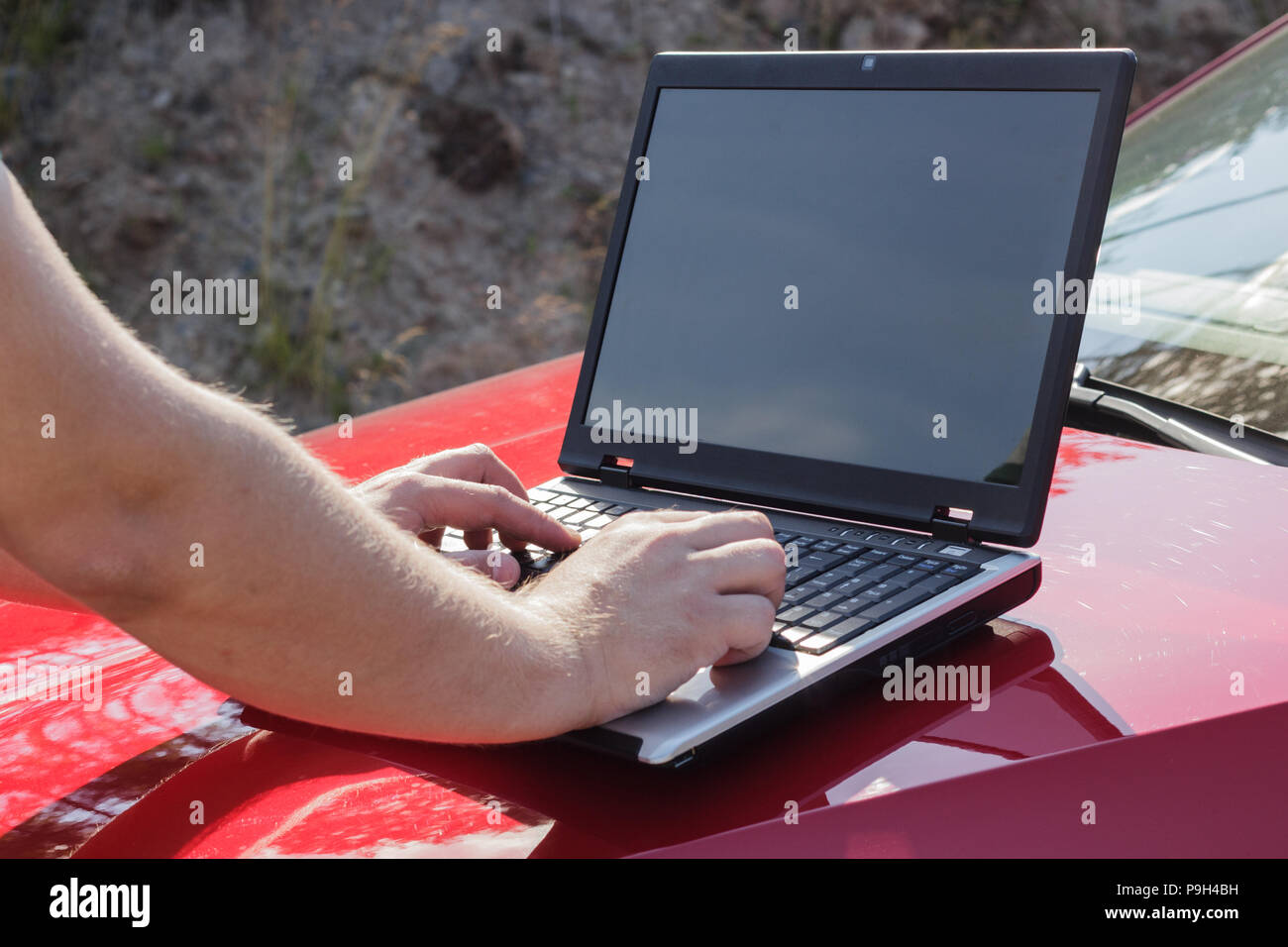 Laptop on hood of car hi-res stock photography and images - Alamy
