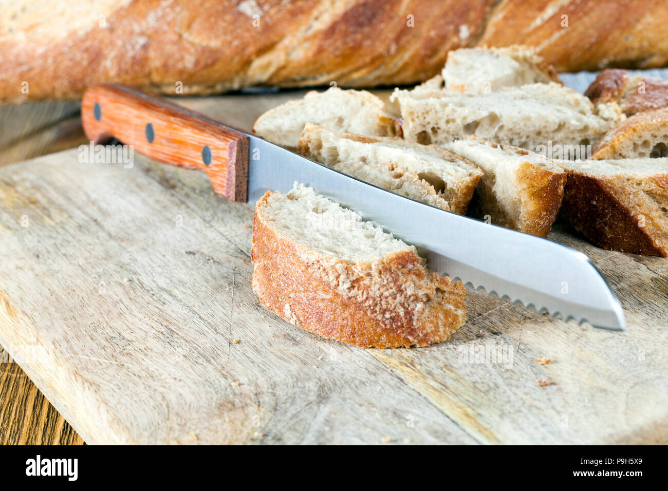 side view of homemade baked white bread cut into pieces on a kitchen ...