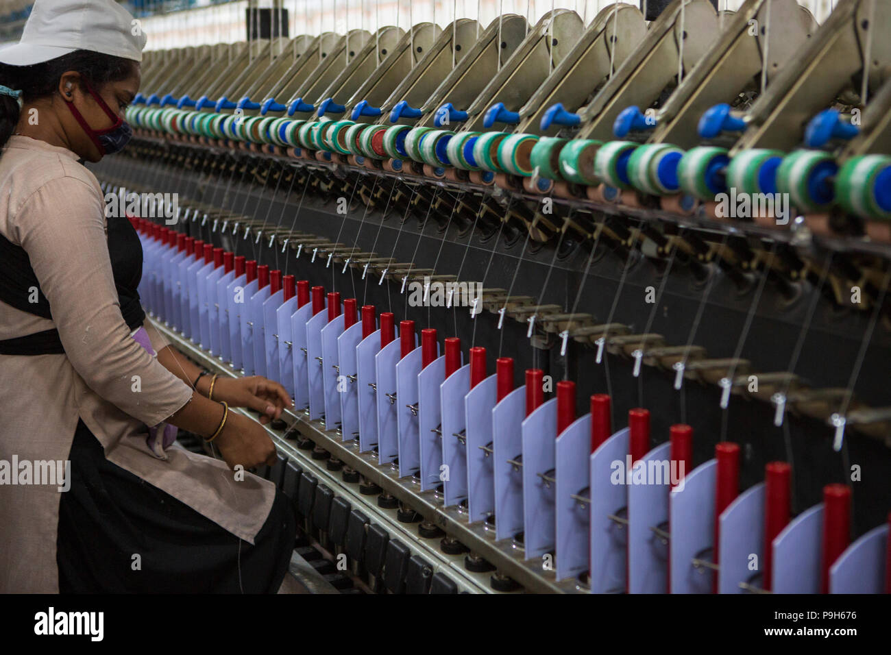 Organic cotton being spun at a garment factory, where organic cotton is ...