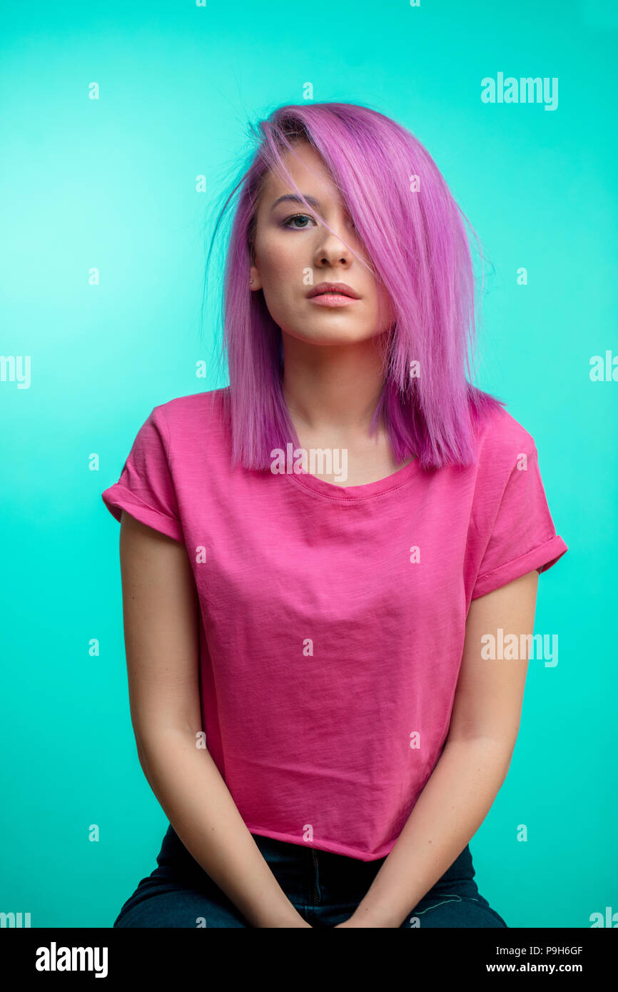 Caucasian model woman having stylish hairstyle, with pink stright hair ...