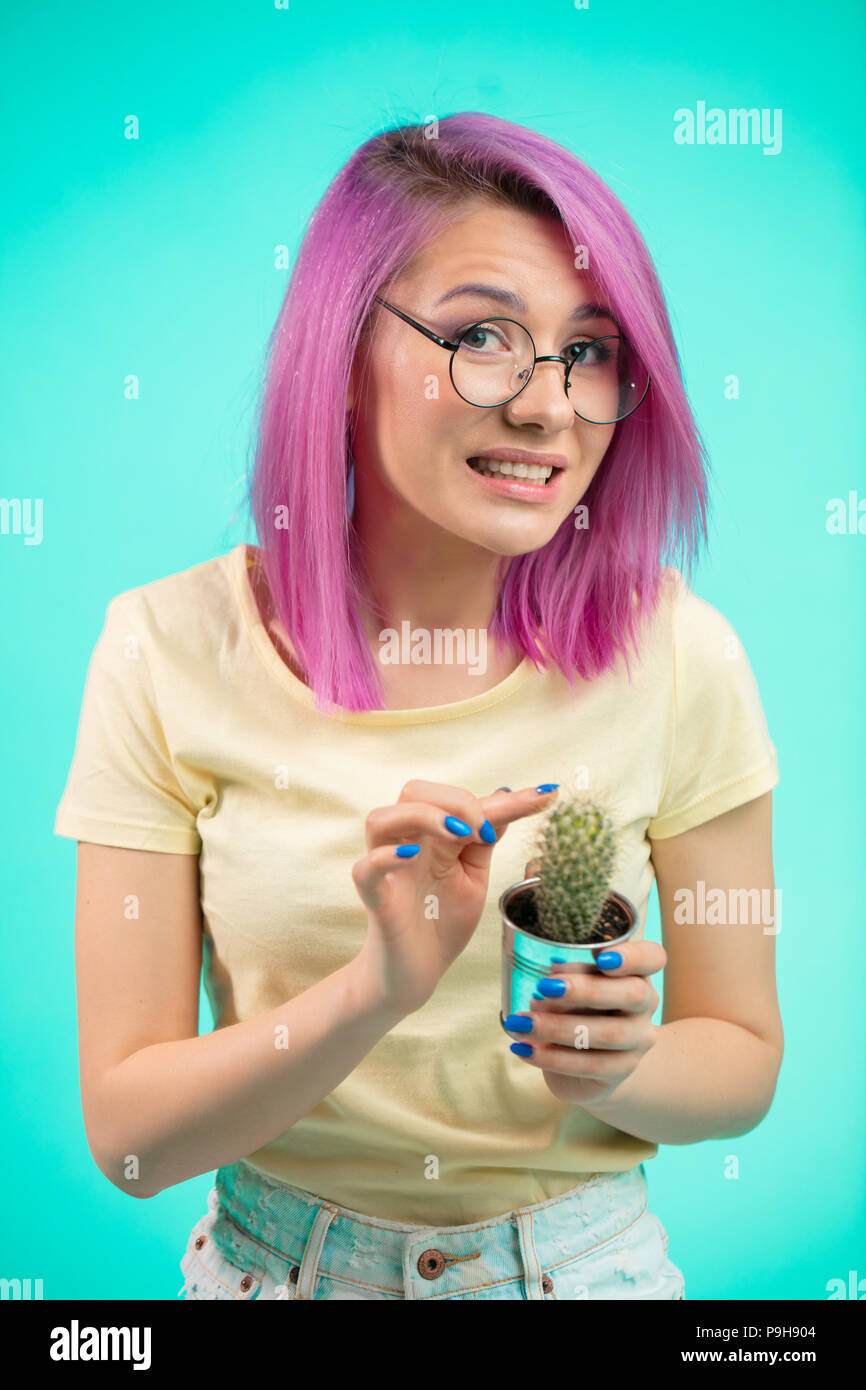 Emotional funny cute woman girl with a small cactus. Closeup face ...