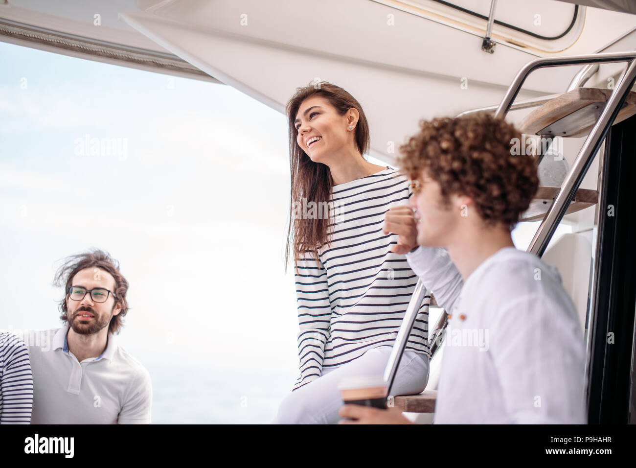 vacation, travel, sea, friendship and people concept - friends talking ...