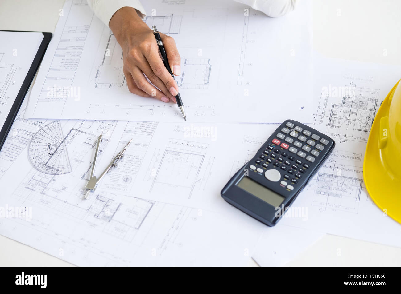 Close-up Of Person's engineer Hand Drawing Plan On Blue Print with ...