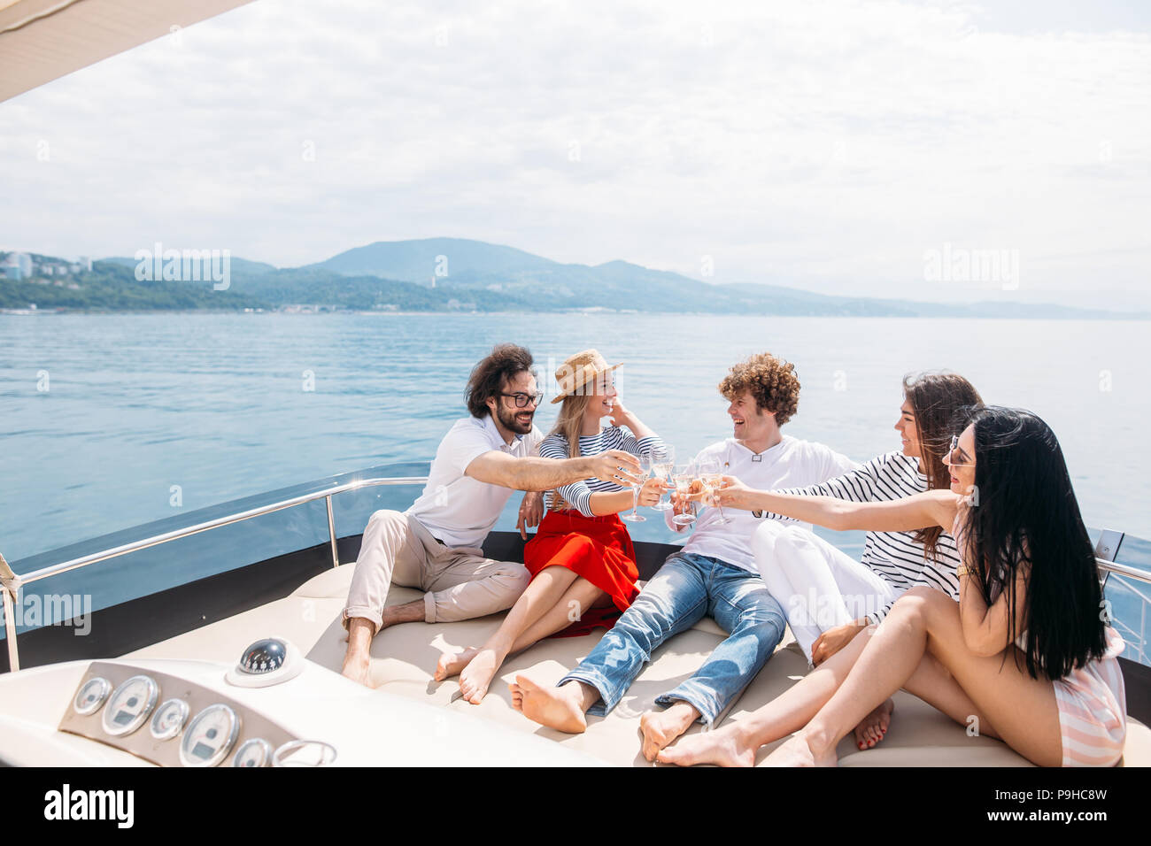 Horizontal portrait of young caucasian people toasting drinks on the ...