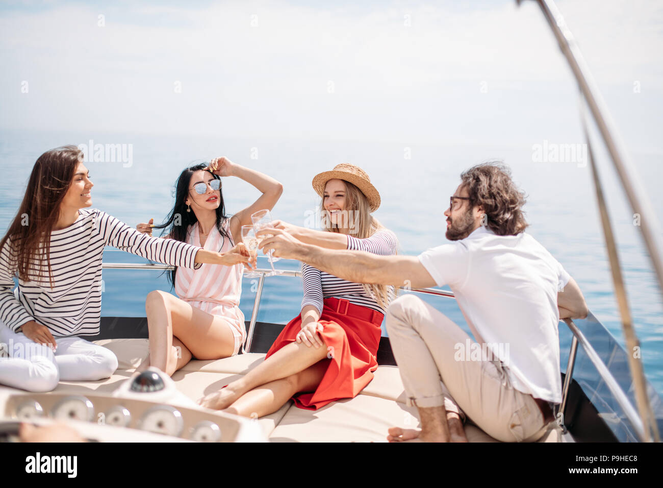 Young european tourists guys and girls celebrating on yacht happy start ...