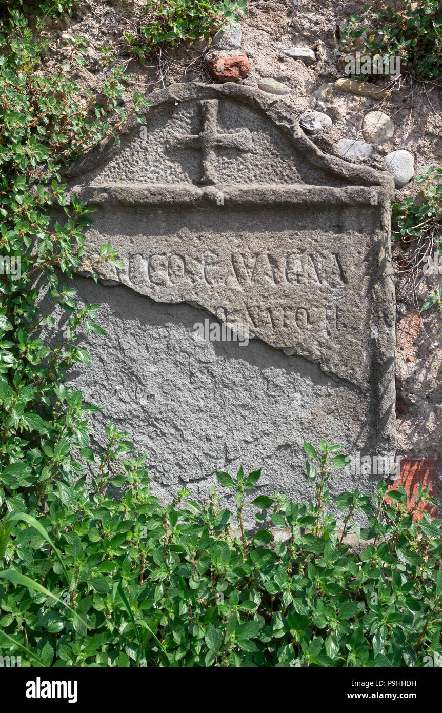 Cemetery. Old grave stone with route inscription. Over time, plants ...