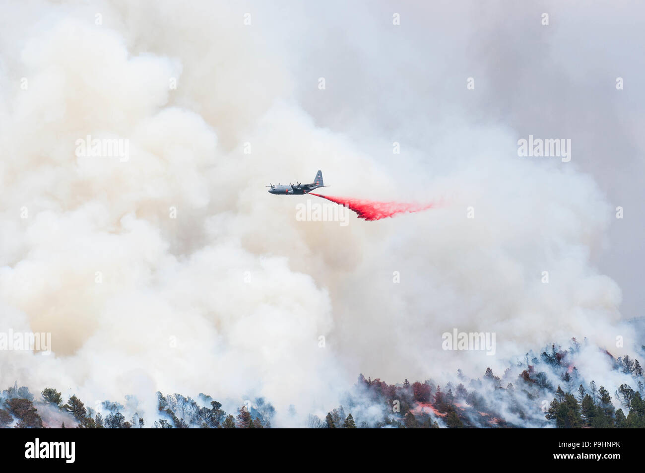 An aircraft drops slurry to support fire suppression efforts July 4 ...