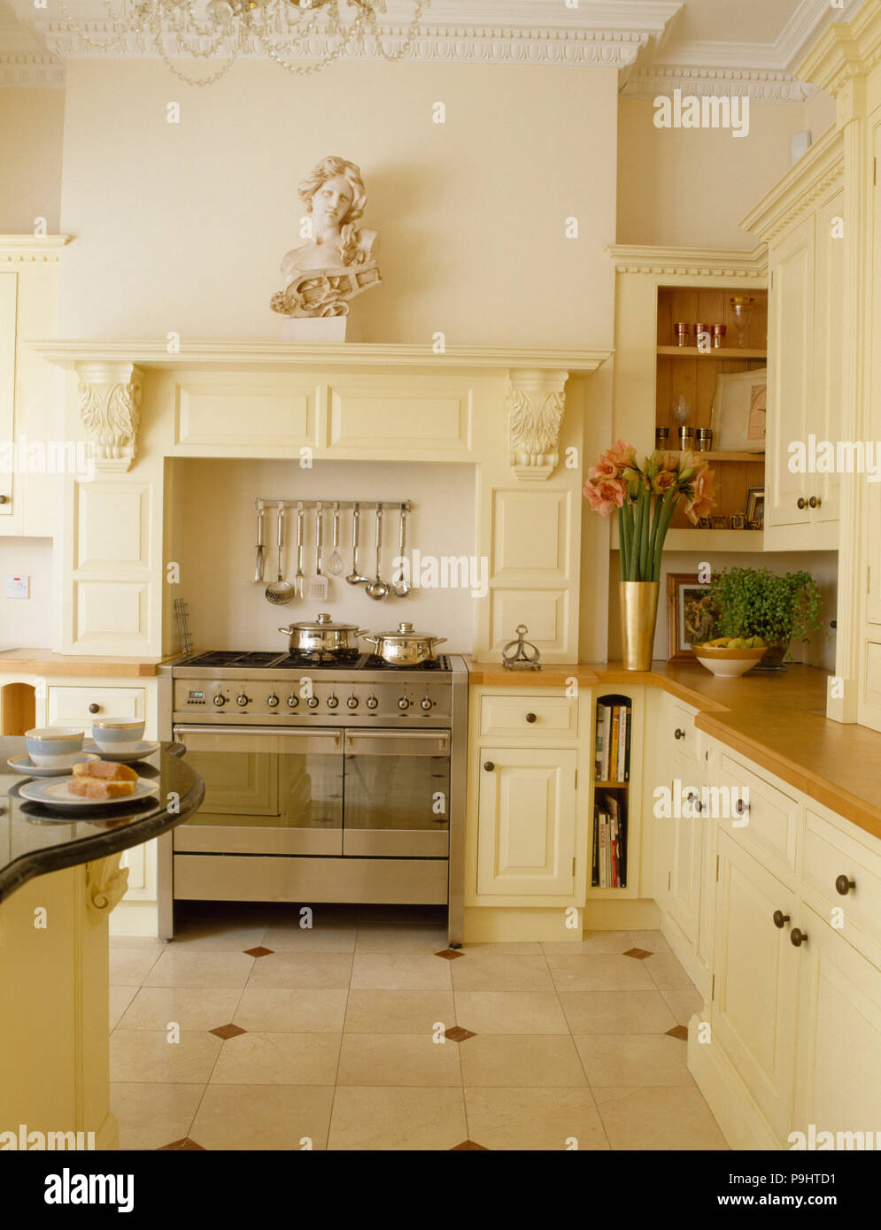 Stainless steel range oven in a large kitchen with cream fitted ...