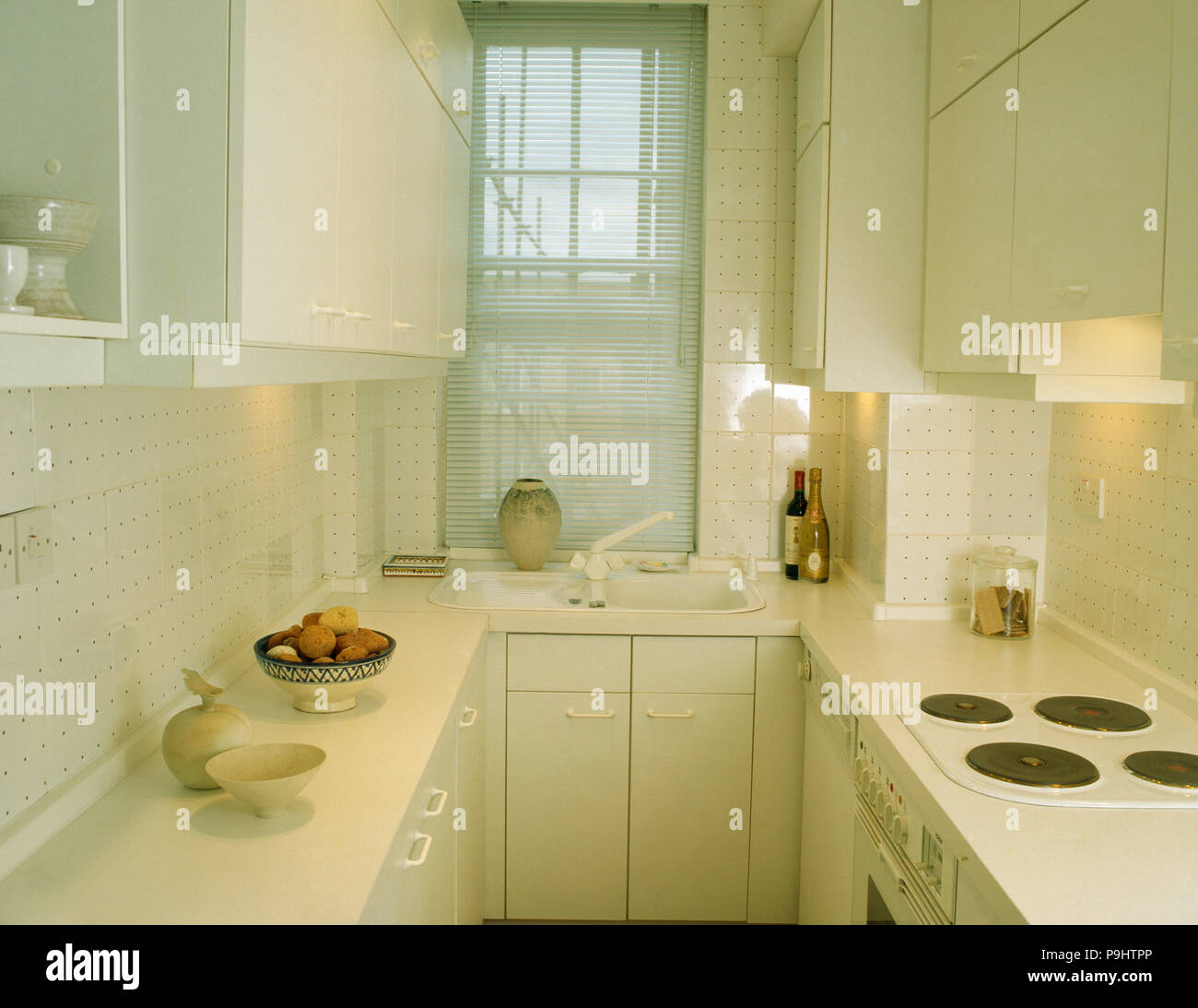 Electric hob in worktop in modern white galley kitchen Stock Photo - Alamy