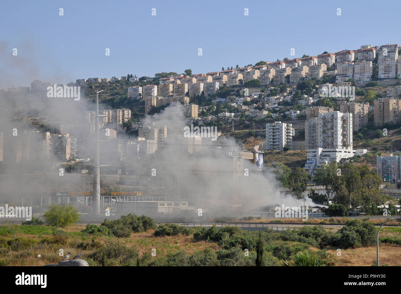 Heavy smoke is seen from a fire in the Haifa recycling facility. Haifa ...