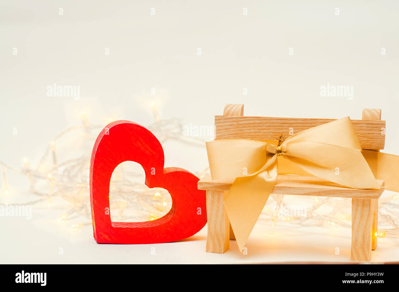 wooden heart with a bow on a bench on a white background. Valentine's ...