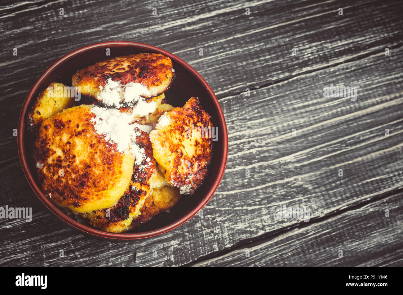 sweet cheese pancakes on a plate on a wooden background, syrniki ...
