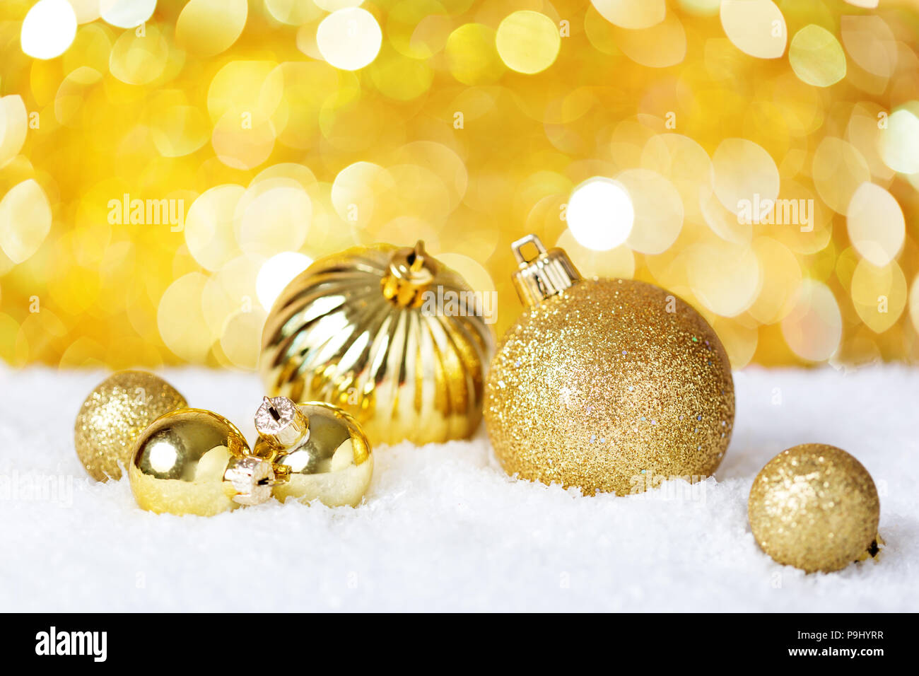 Gold Christmas balls on the shiny background. Very shallow depth of ...