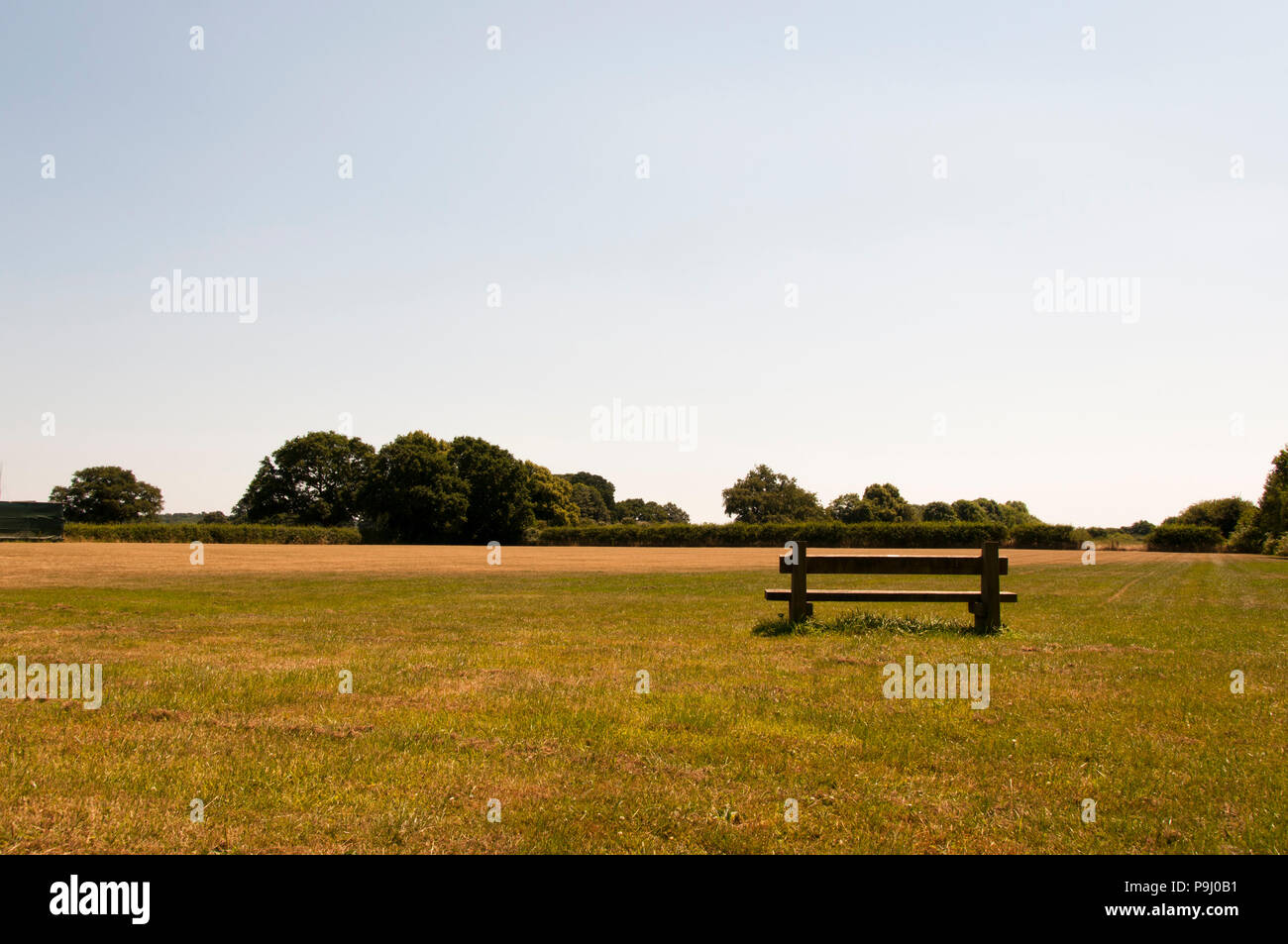 A single bench looking onto an empty field. A good place to sit and ...