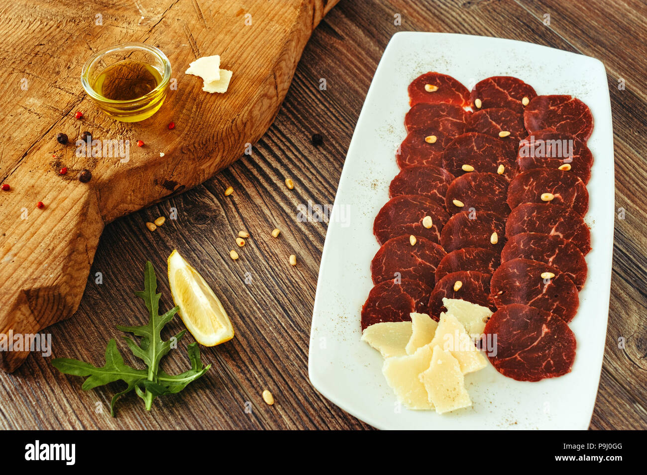 Beef carpaccio with parmesan cheese, olive oil and spices Stock Photo ...