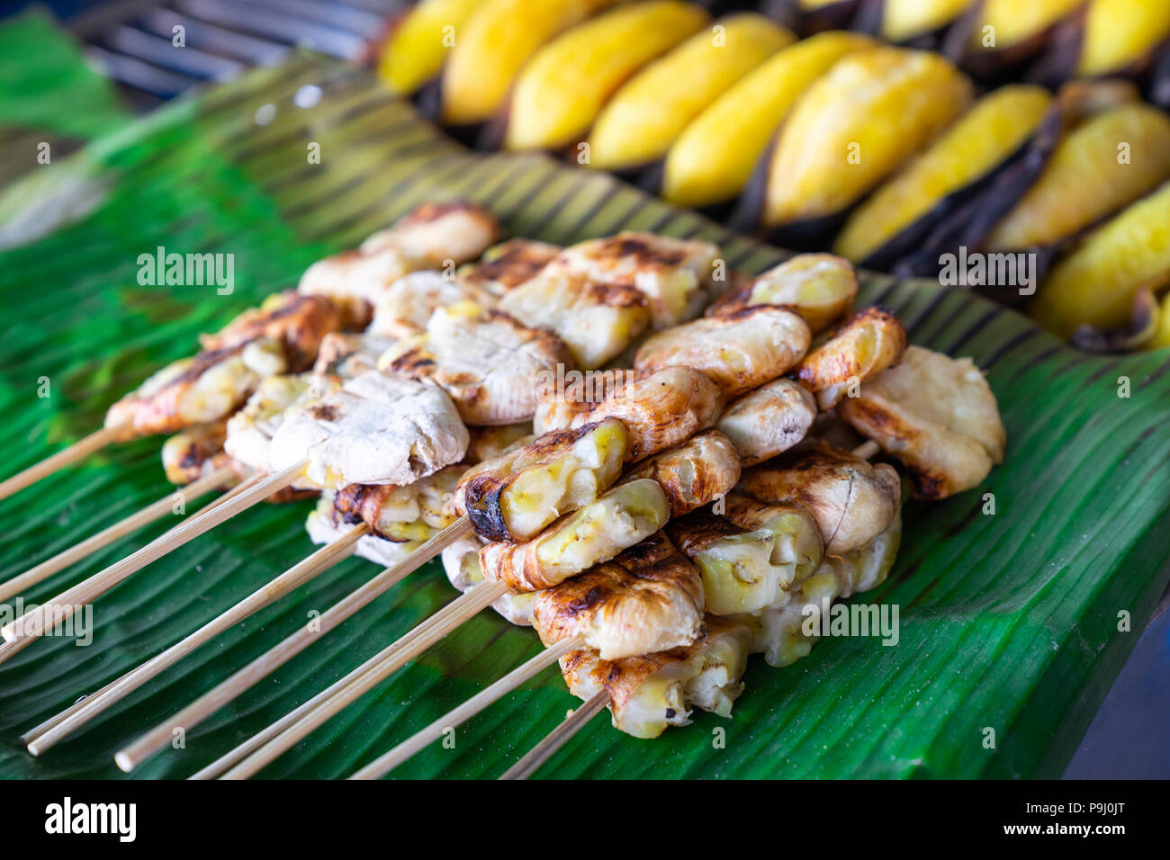 Grilled slice Banana skewers on green banana leaf, in Thailand ...