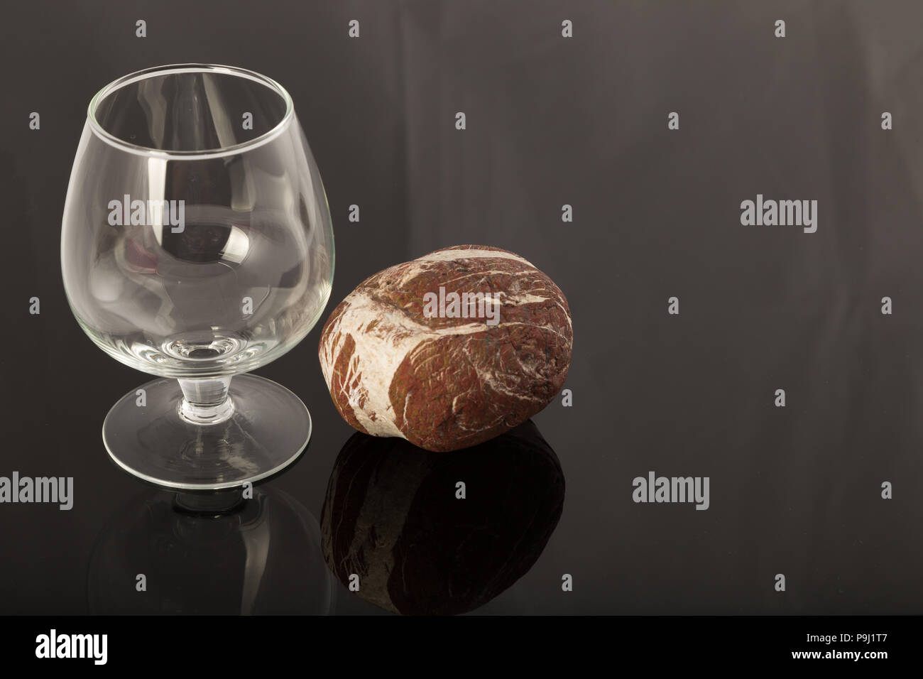 Natural stone and a glass on the varnished coating, the reflection of ...