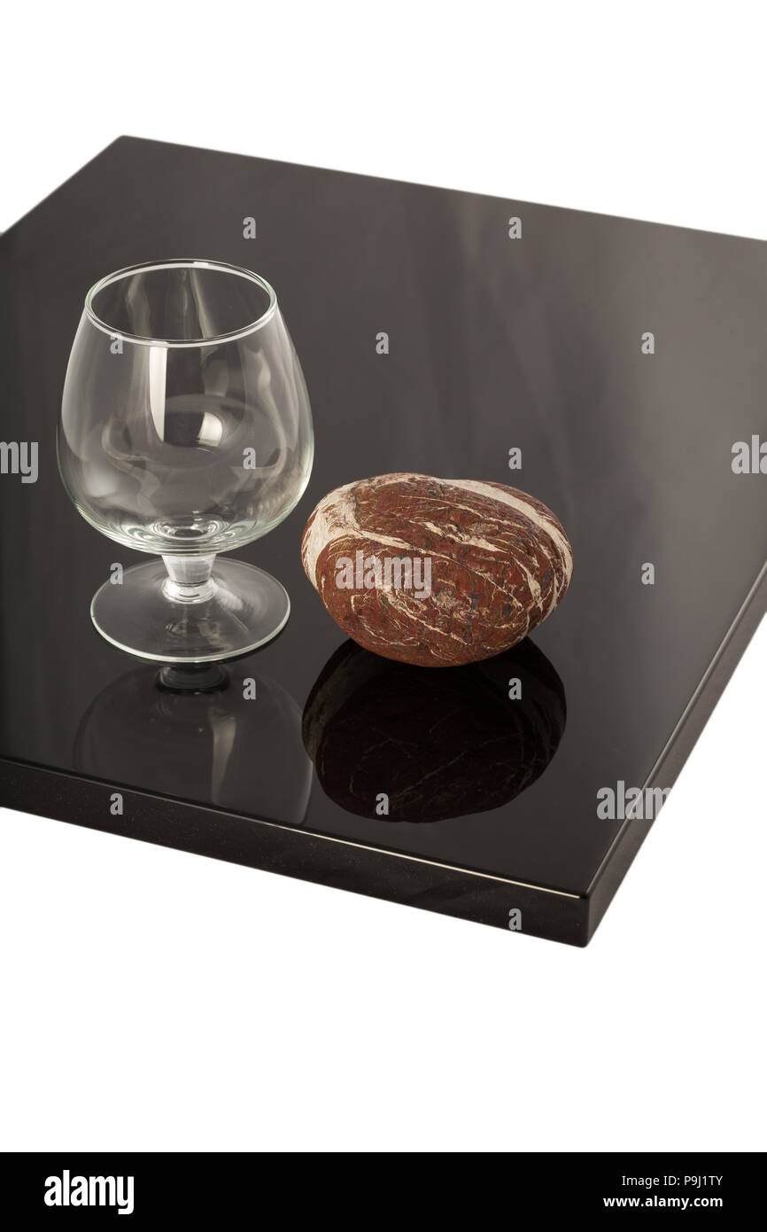 Natural stone and a glass on the varnished coating, the reflection of ...