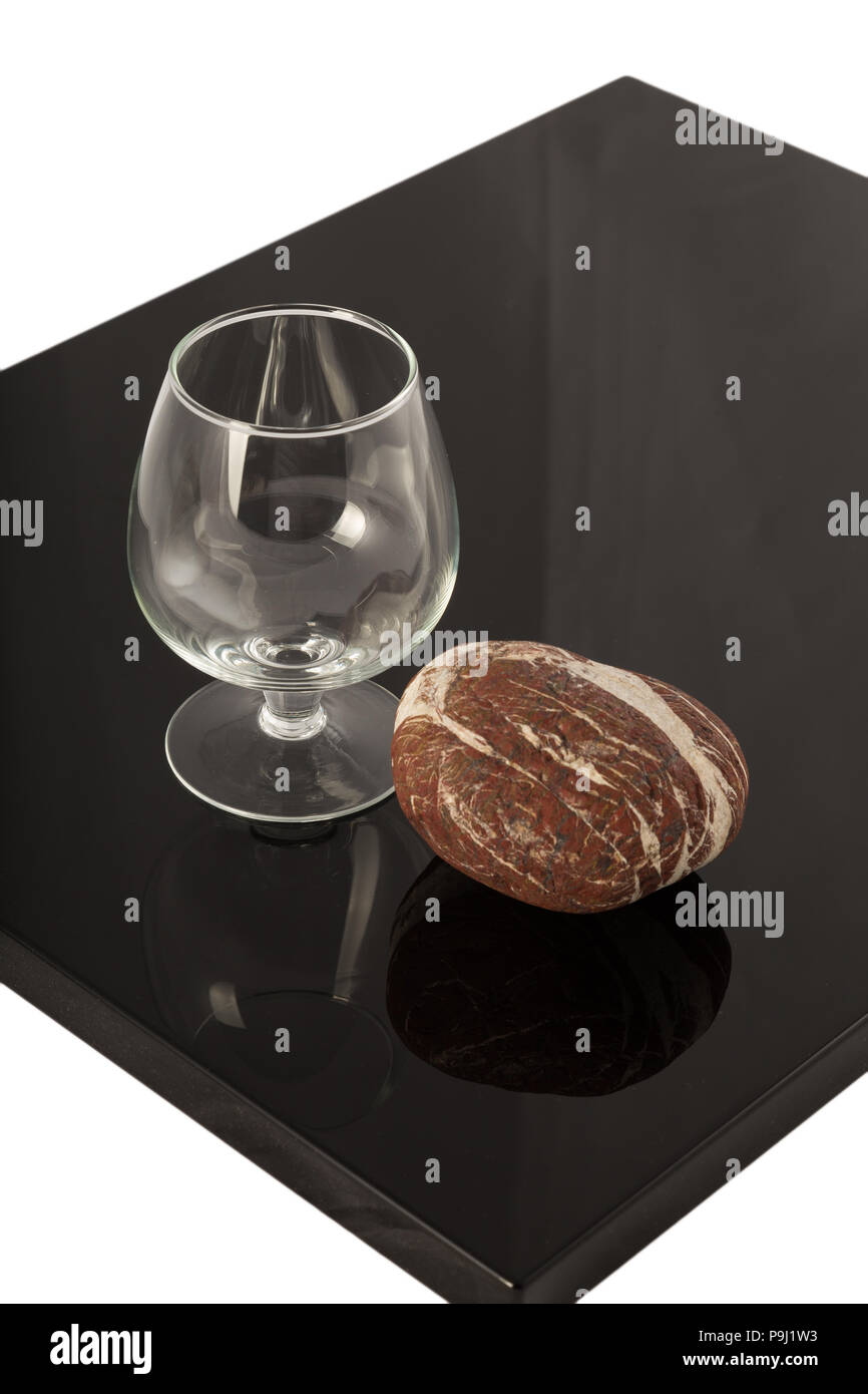 Natural stone and a glass on the varnished coating, the reflection of ...
