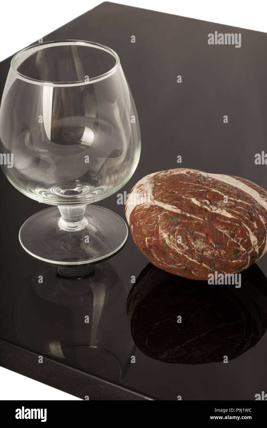 Natural stone and a glass on the varnished coating, the reflection of ...