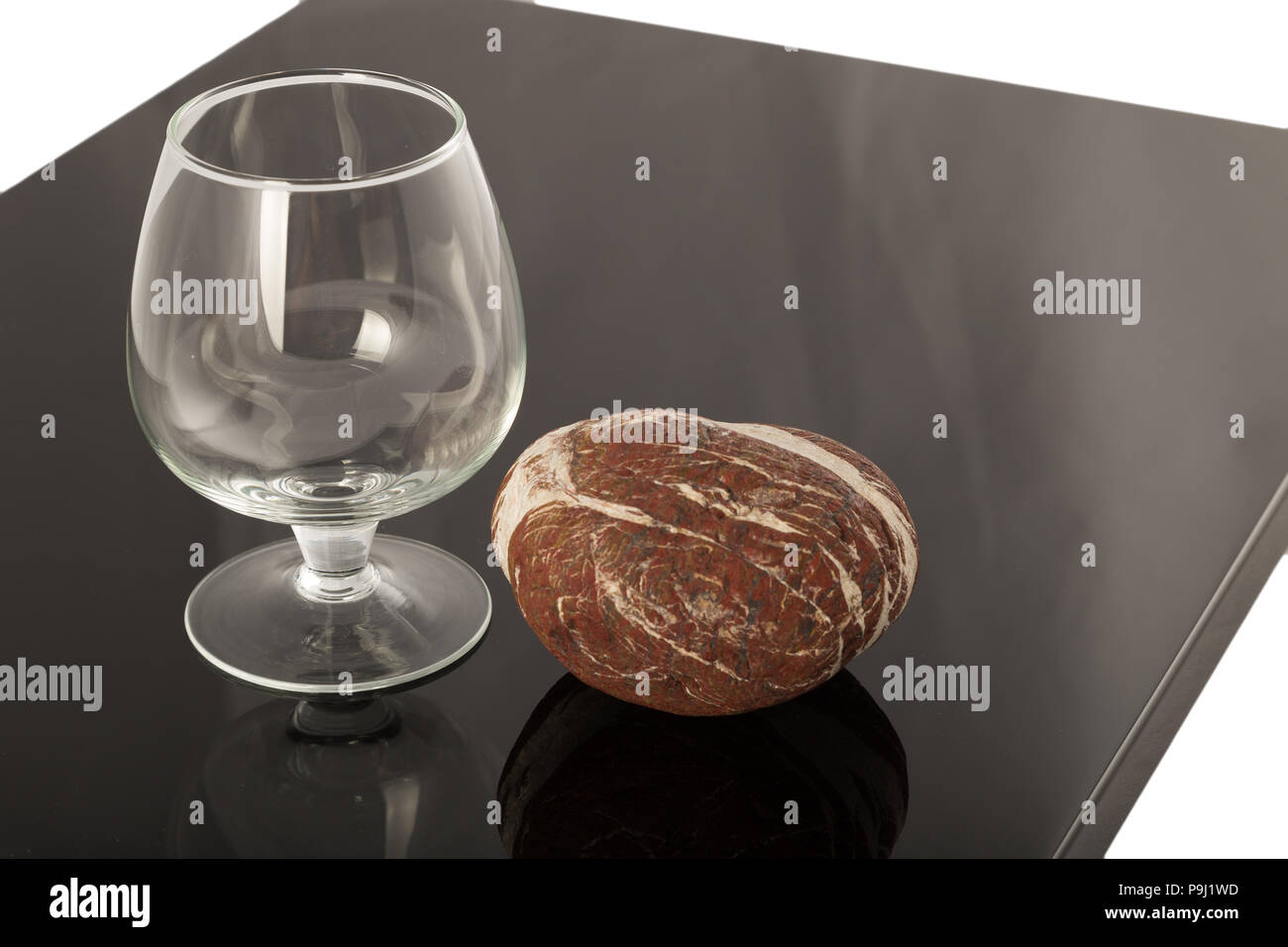 Natural stone and a glass on the varnished coating, the reflection of ...
