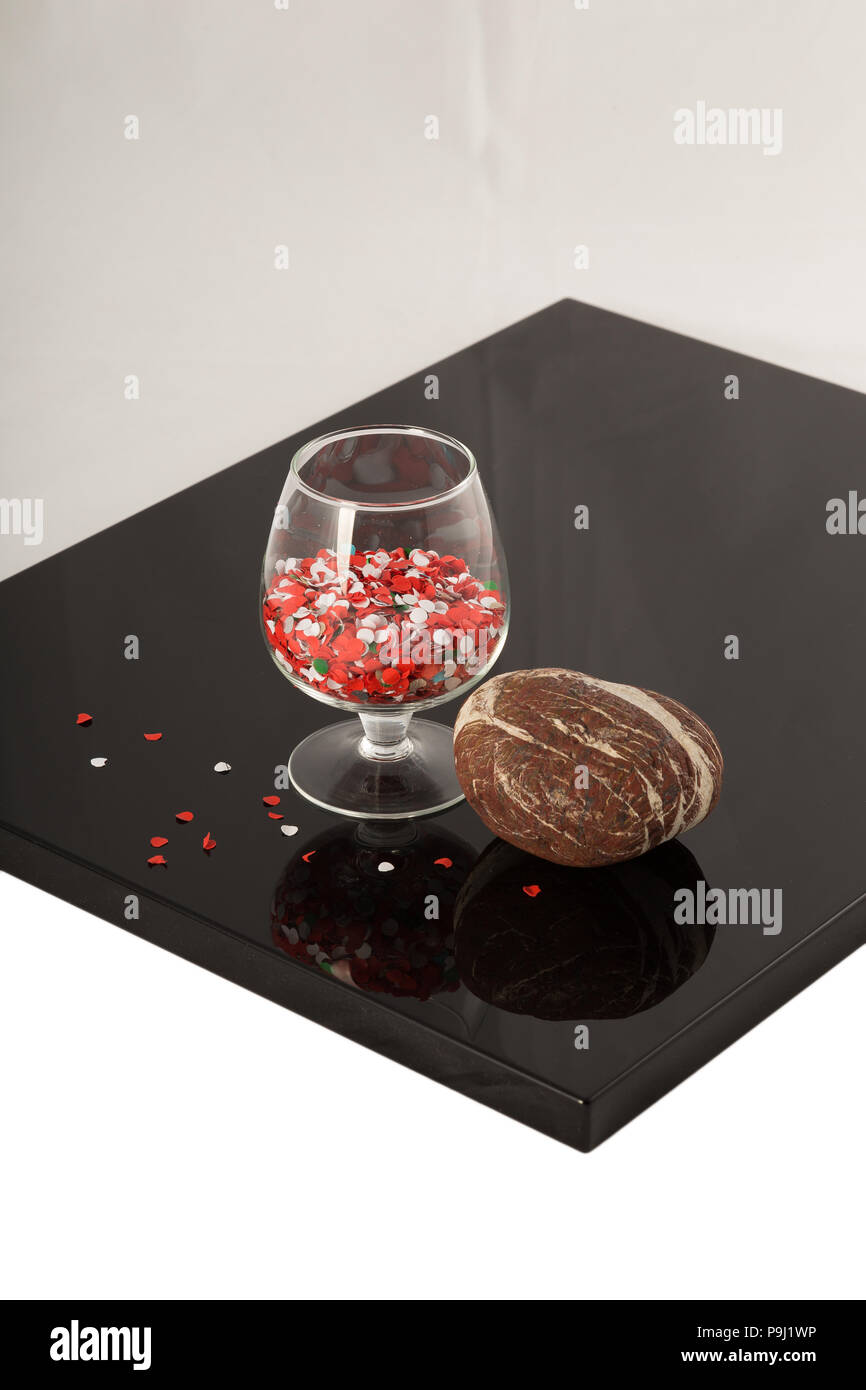 Natural stone and a glass on the varnished coating, the reflection of ...