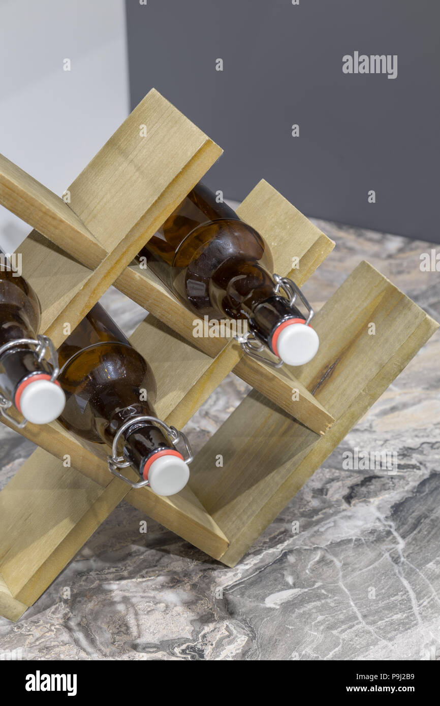 Wooden stand for bottles on the table in the kitchen Stock Photo - Alamy