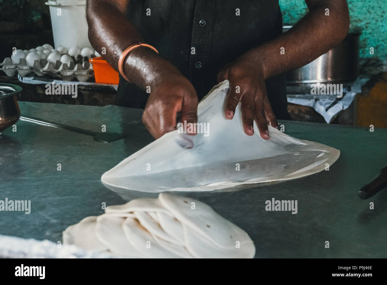 Making dough bread. Indian chef prepares a big cake. street food in ...