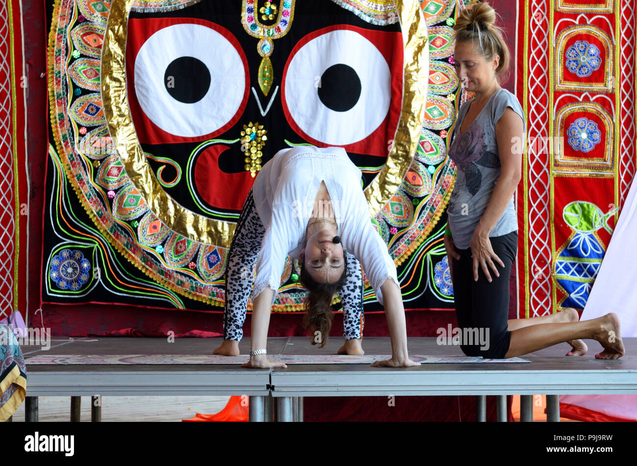 People practicing yoga poses during festival of Yoga and Vedic Culture ...