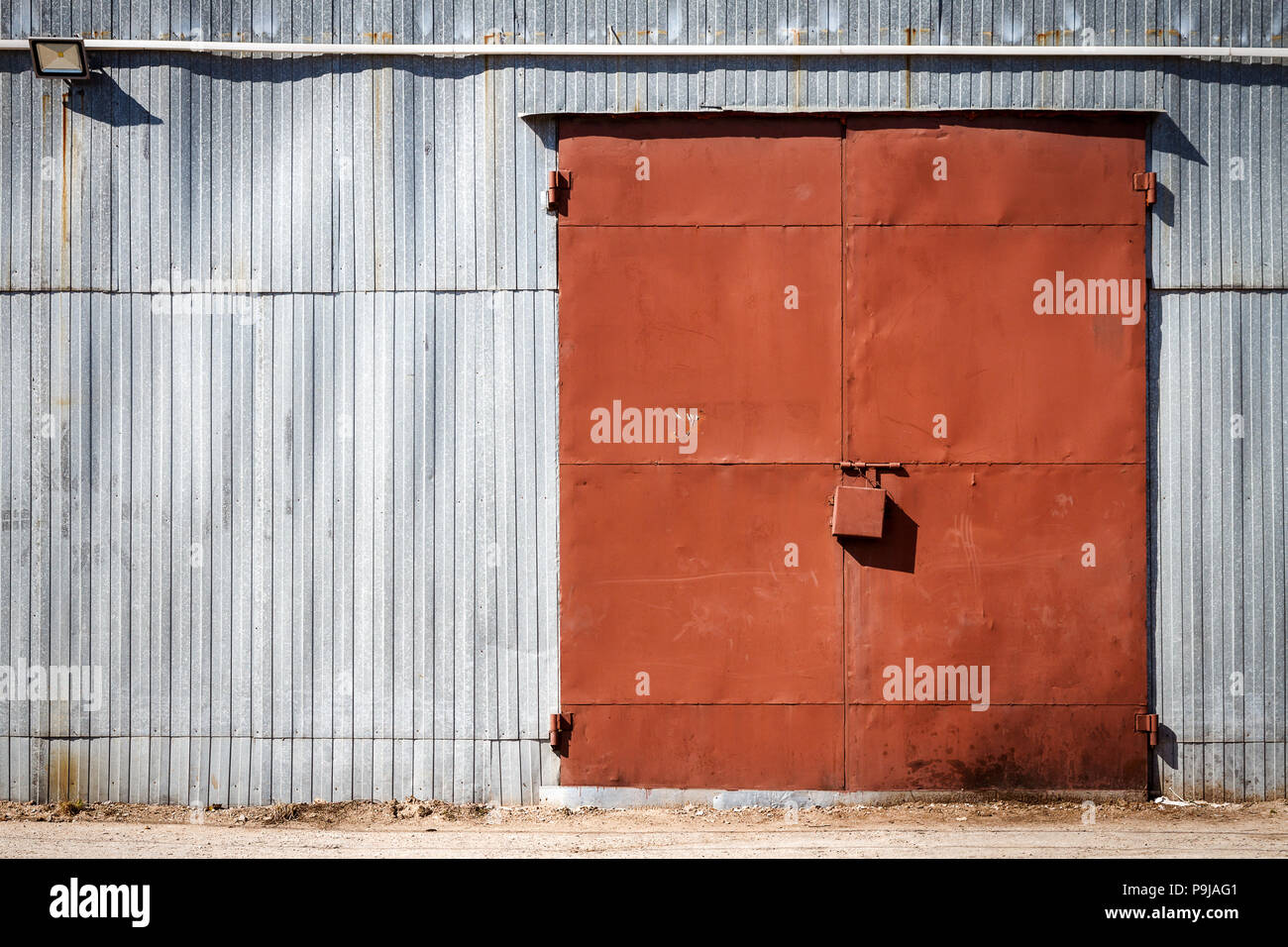 Old metal warehouse door, hangar gate. Industrial iron door Stock Photo ...