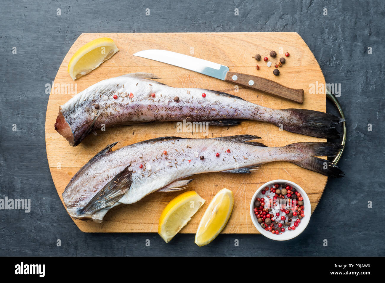 Slave raw Fish on wooden cutting Board on dark background Stock Photo ...