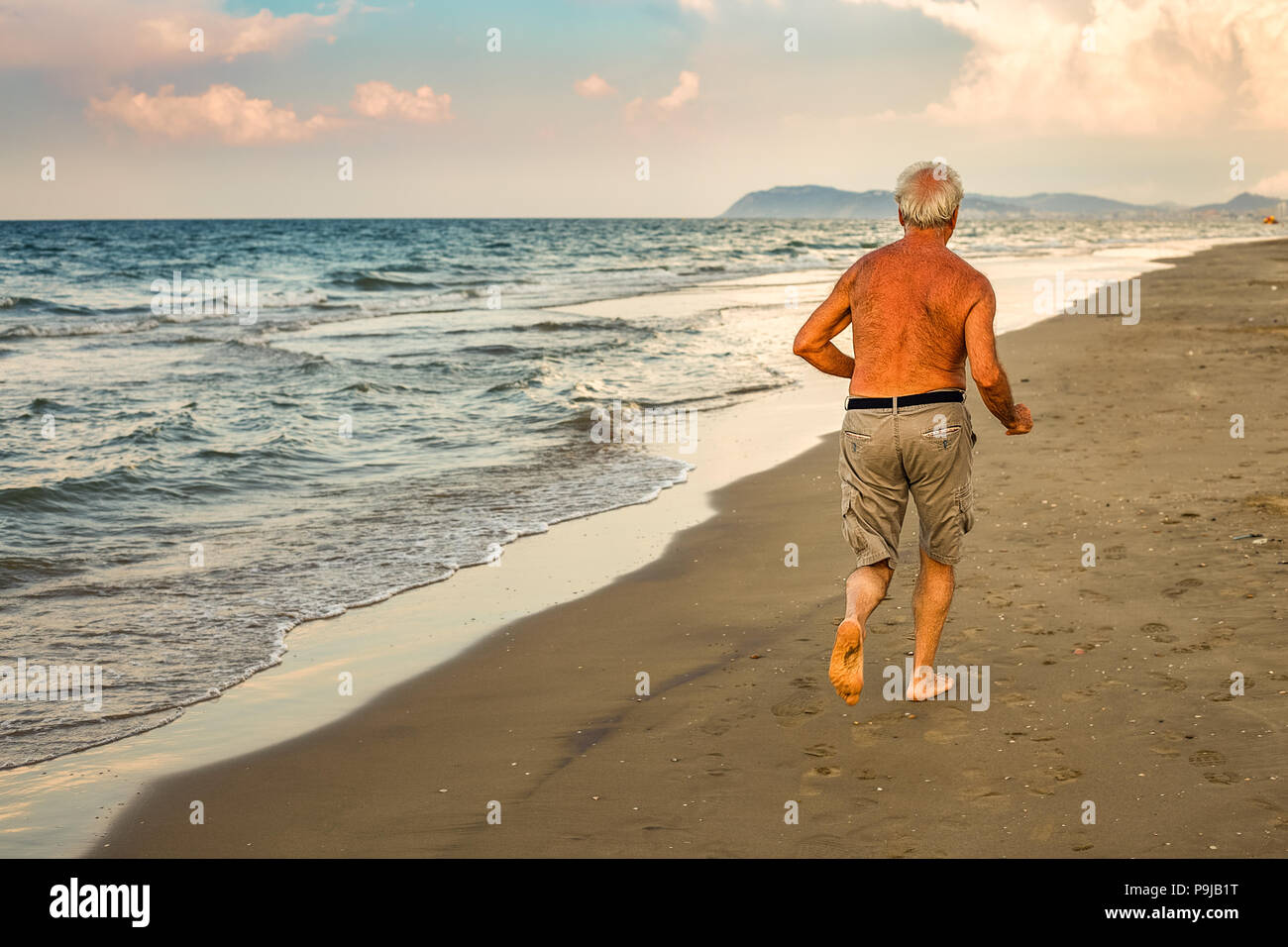 elder running on the shoreline Stock Photo - Alamy