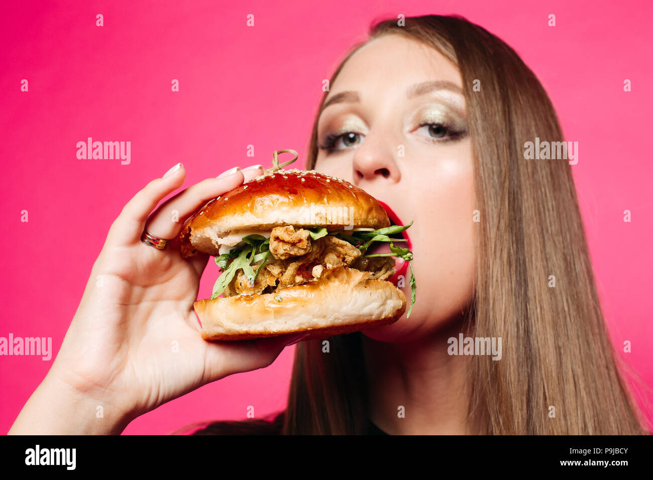 Teen biting into burger hi-res stock photography and images - Alamy