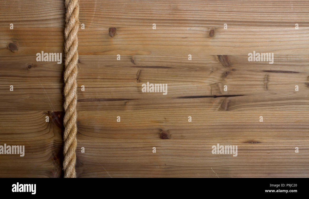 rough rope on a simple wooden light brown background Stock Photo - Alamy