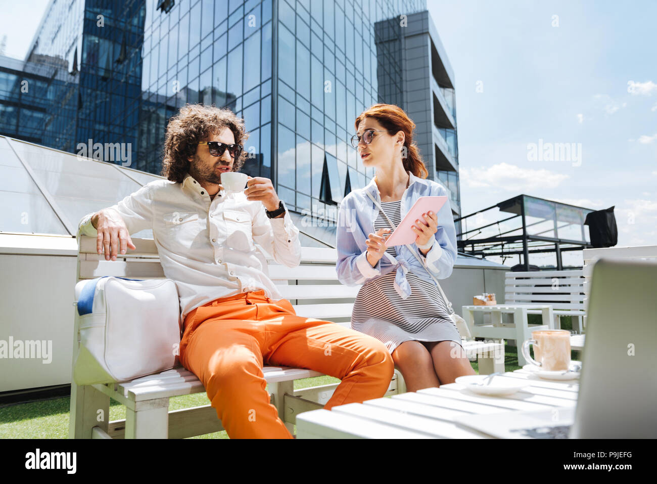 Two old friends meeting each other on summer terrace Stock Photo - Alamy