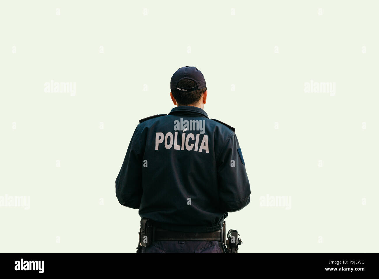 Isolated on white background a policeman is standing with his back in ...