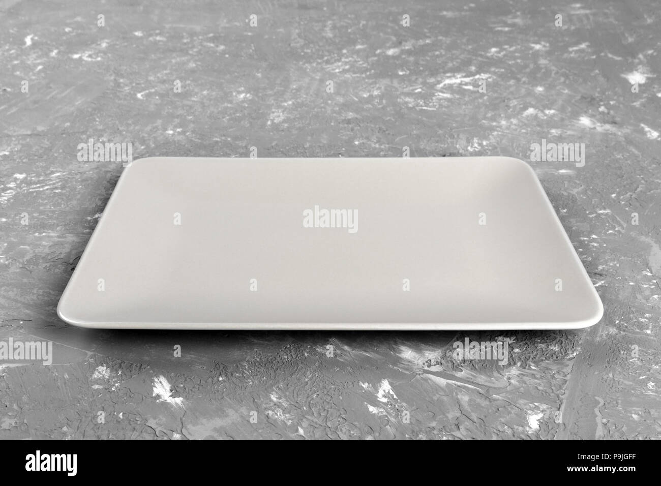 empty rectangular Plate on gray table background Stock Photo - Alamy