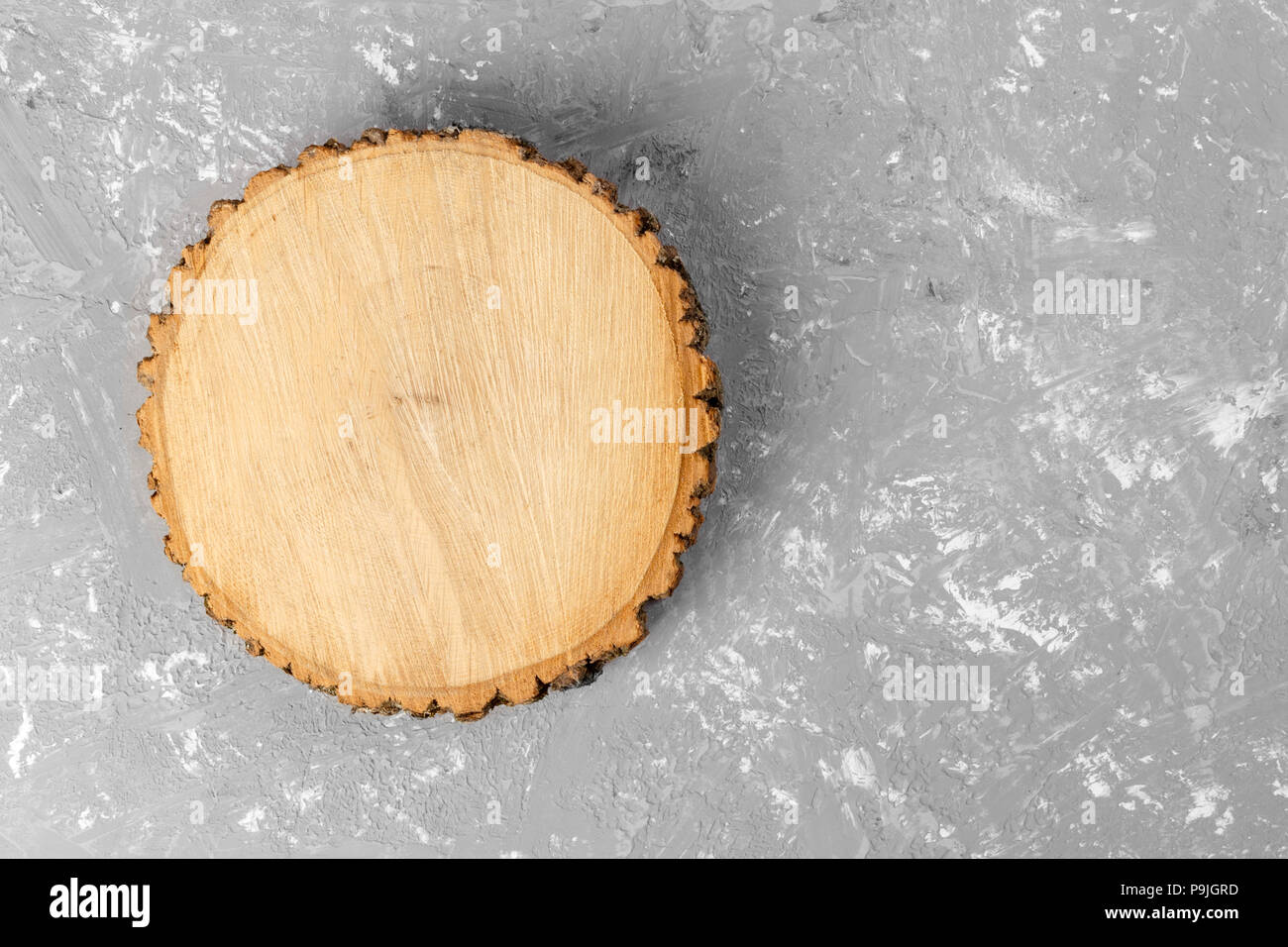 Tree stump round cut with annual rings on cement background. top view ...