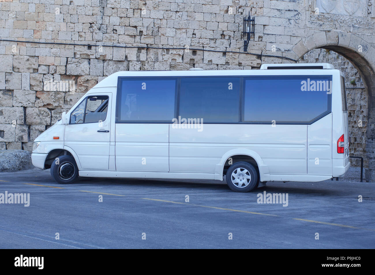 White mini Van bus parked on street waiting for passengers transport ...