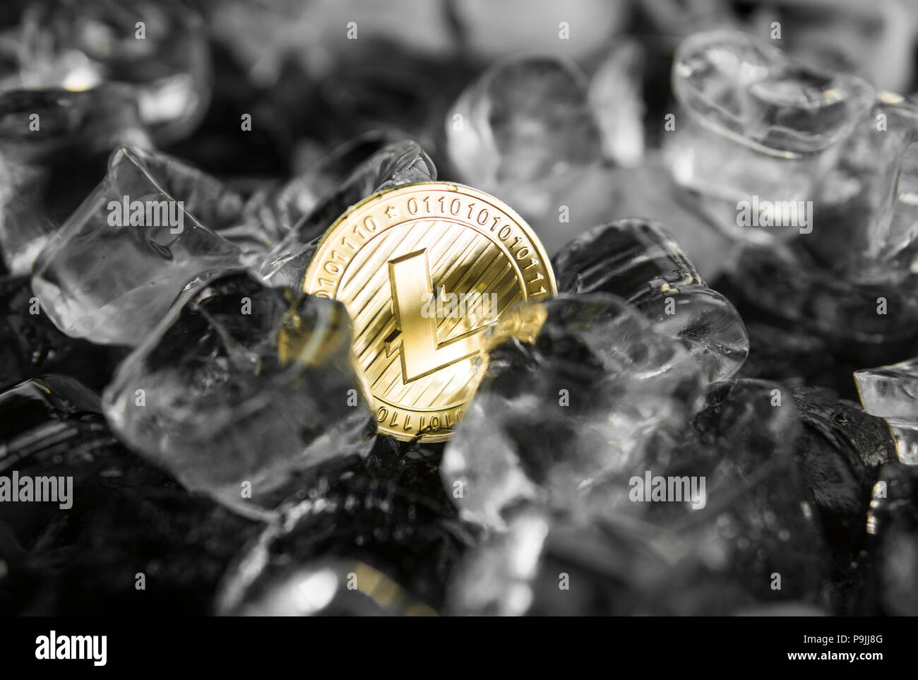 Gold litecoin coin on ice background. Mining litecoins. The concept of ...
