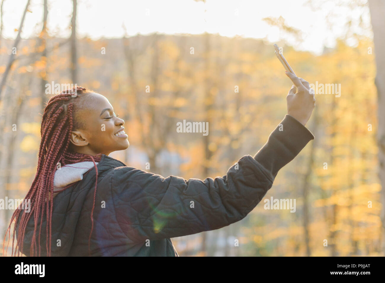 African girl taking selfie making kiss hi-res stock photography and ...