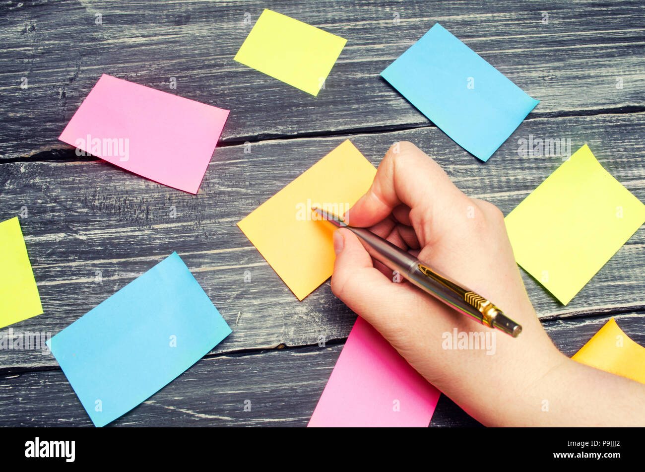 sticky stickers for notes on a black wooden background. time management ...