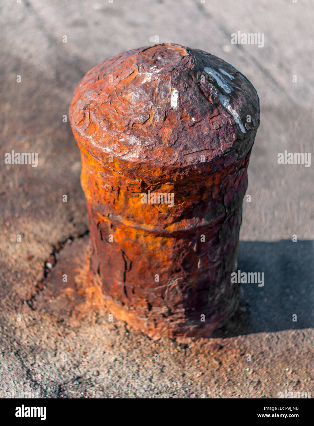 Very old iron bollard on concrete marine dock for boat Stock Photo - Alamy