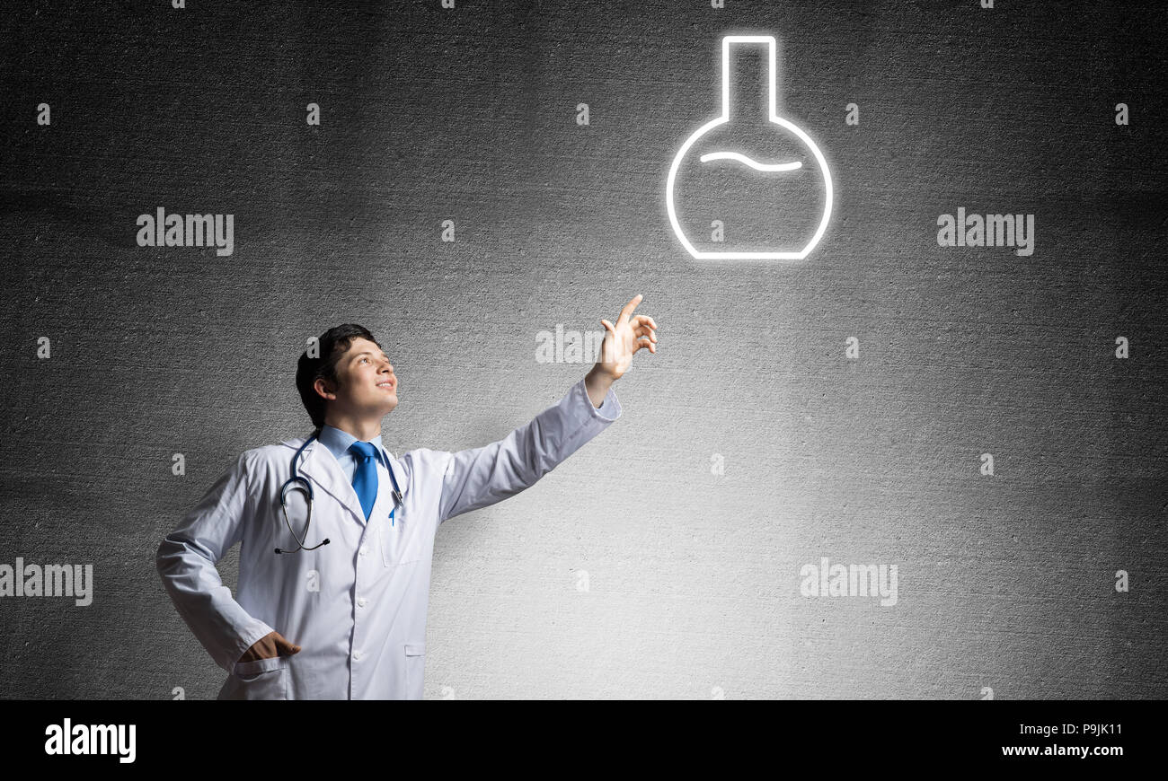 Doctor and vial symbol Stock Photo - Alamy